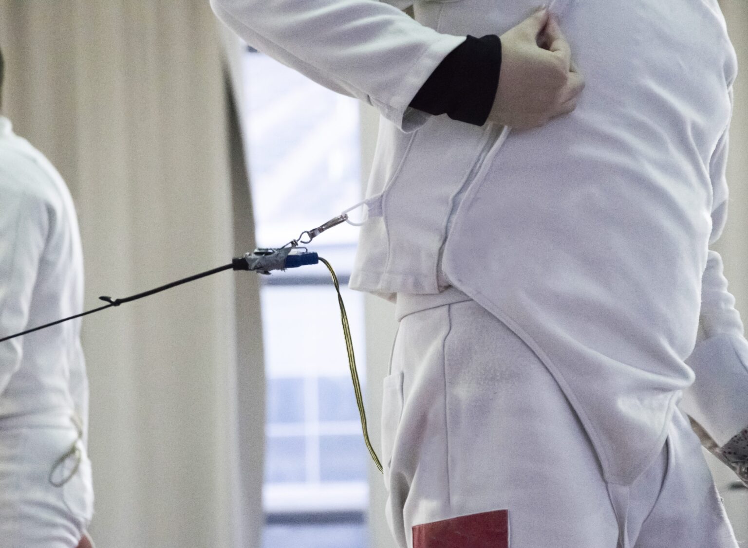Why are fencing athletes attached to metal electric cables? Here's what ...